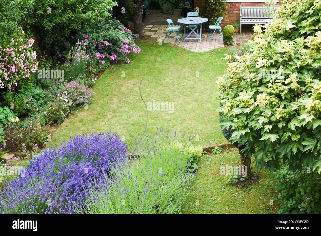 A well kept back yard or garden with lawn and seating area, high angle ...