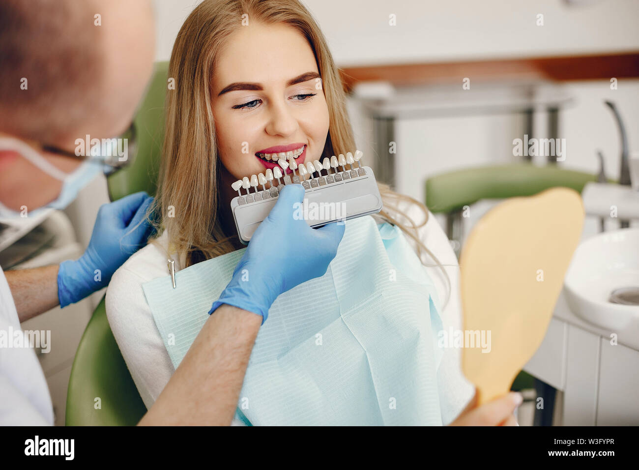 Beautiful girl sitting in the dentist's office Stock Photo - Alamy