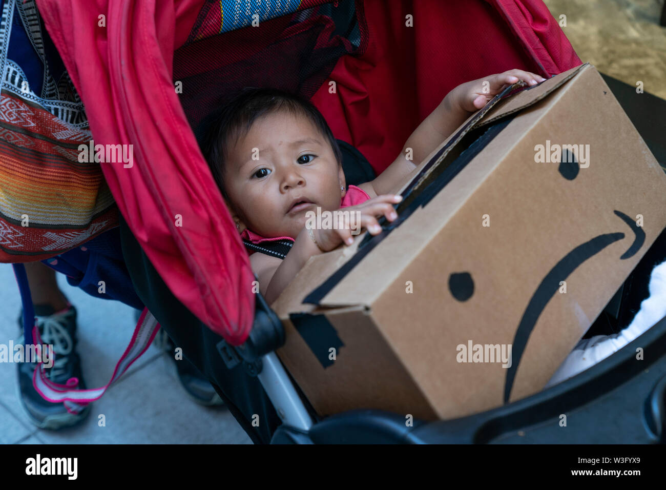 New York, NY - July 15, 2019: Unidentified baby holds box at rally to ...