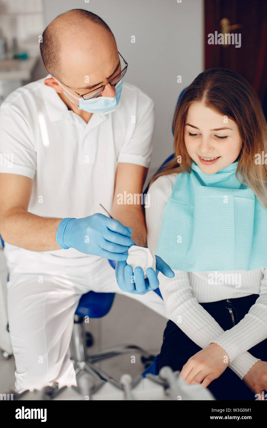 Beautiful girl sitting in the dentist's office Stock Photo - Alamy