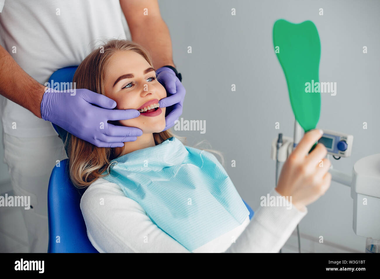 Beautiful girl sitting in the dentist's office Stock Photo - Alamy