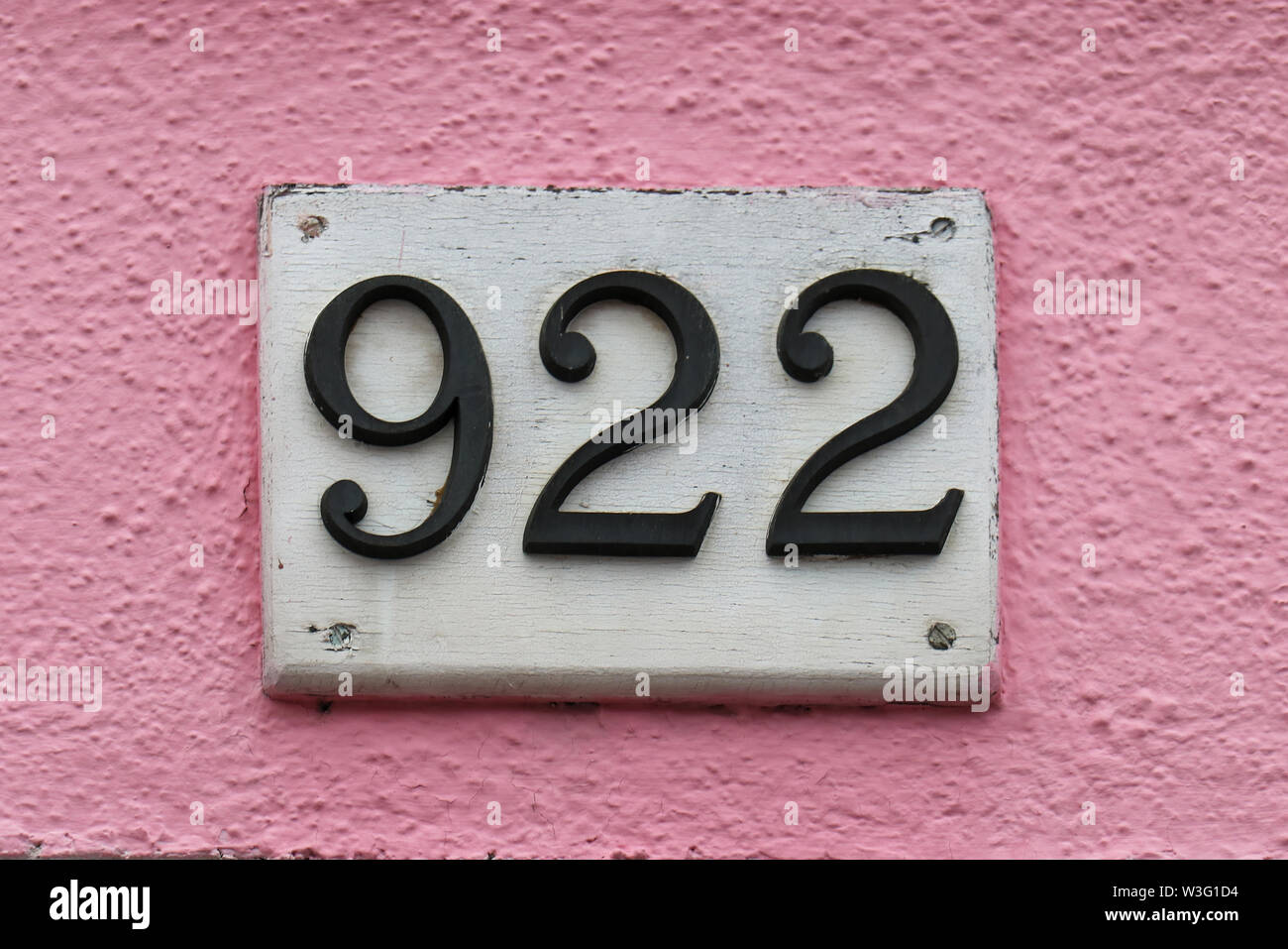 Residential house number on pink facade wall Stock Photo - Alamy