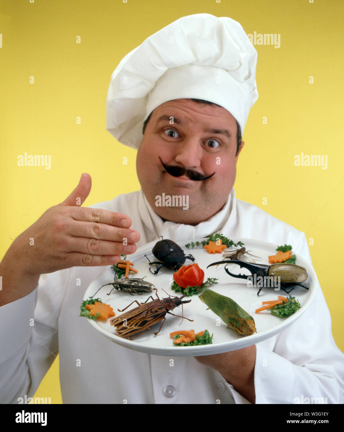 Chef holding platter of goodies Stock Photo - Alamy