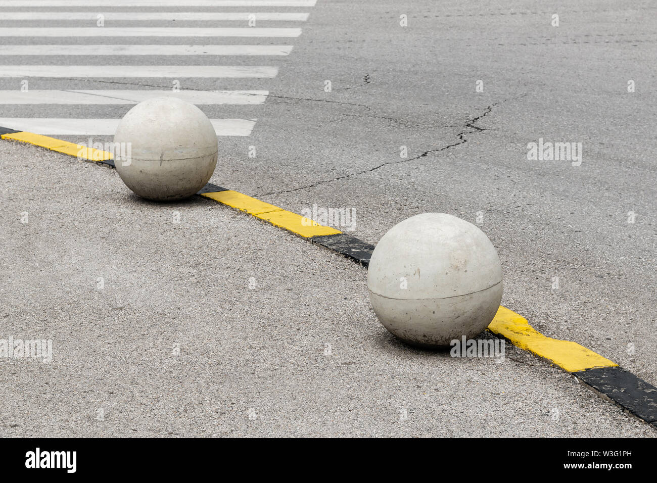 Two concrete balls as a border between sidewalk and road Stock Photo ...