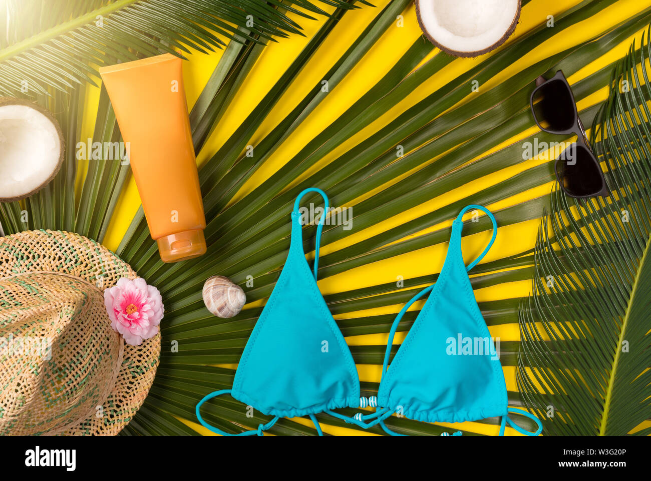 Beach theme on yellow background. Beach accessories and palm leaves on ...