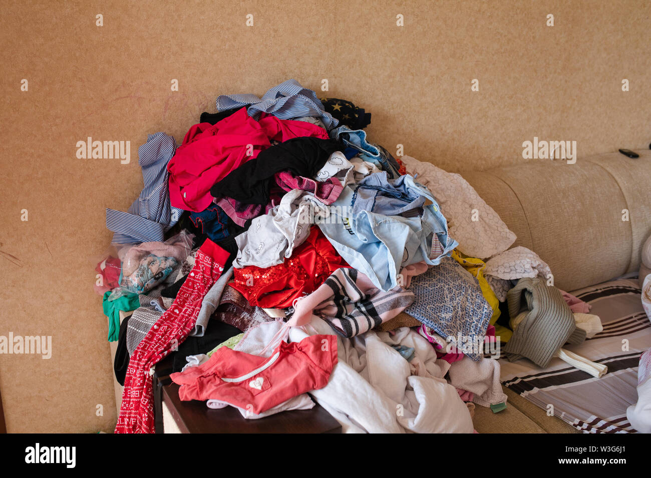 Front view of clothes scattered on sofa at home Stock Photo - Alamy