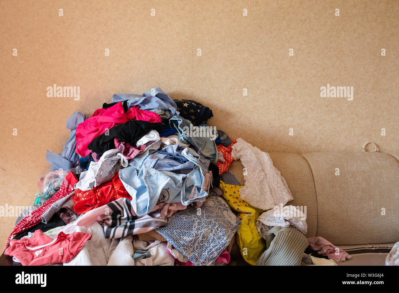 Front view of clothes scattered on sofa at home Stock Photo - Alamy