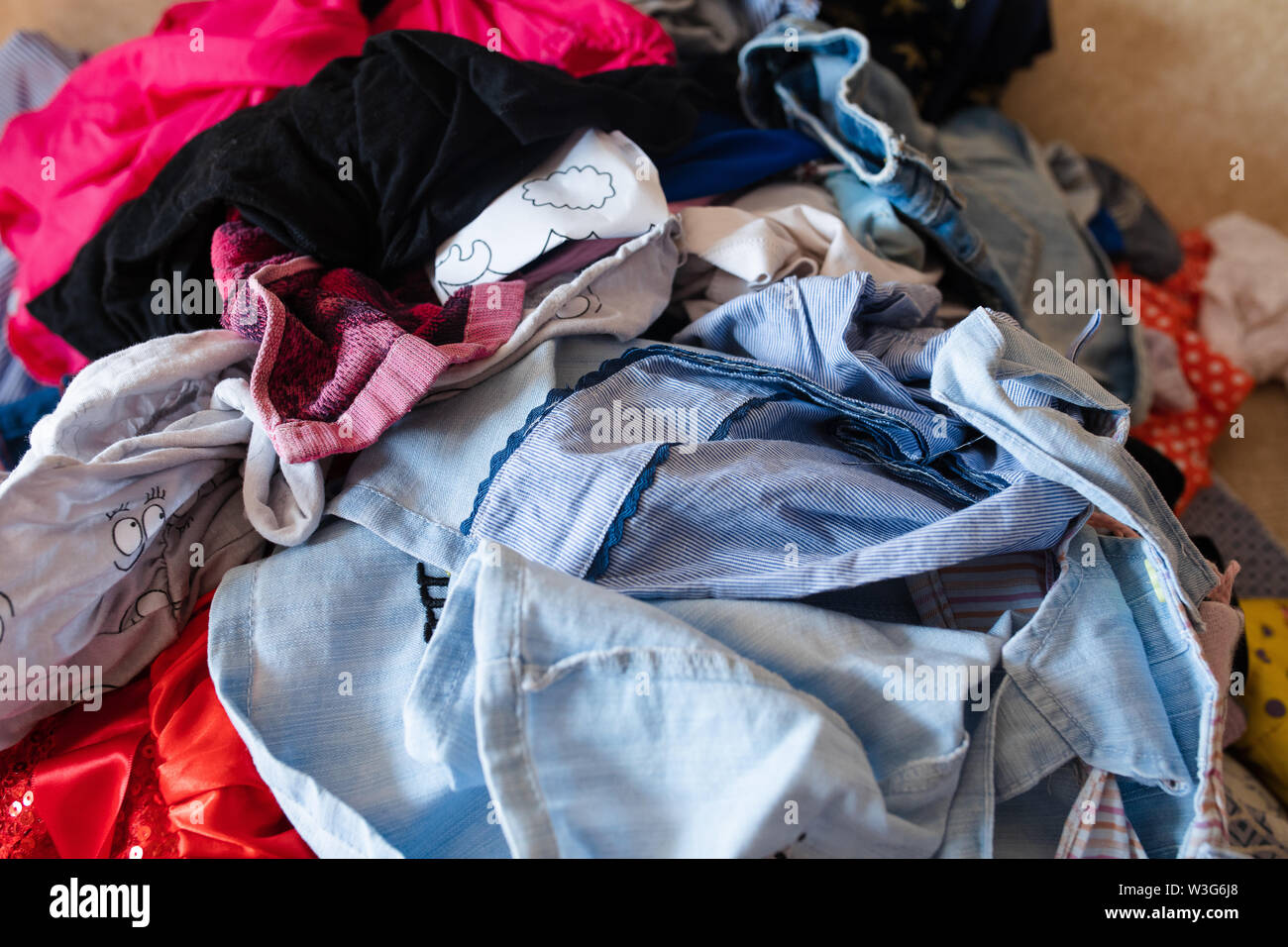 Front view of clothes scattered on sofa at home Stock Photo - Alamy