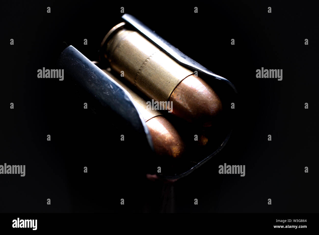 .45 caliber submachine gun cartridges in box magazine on black ...
