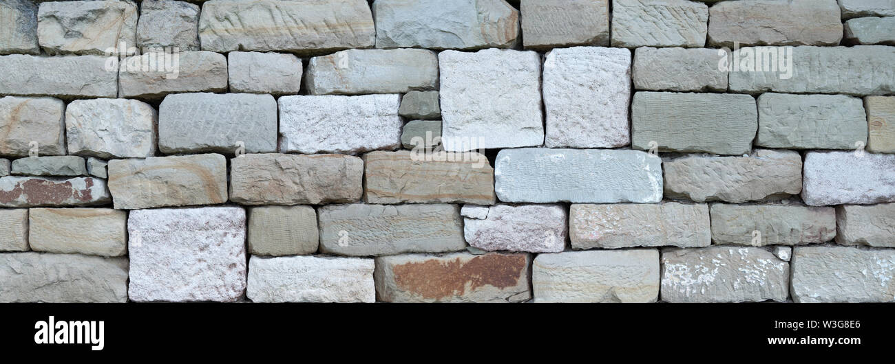 Old stone wall made of square natural stones Stock Photo - Alamy