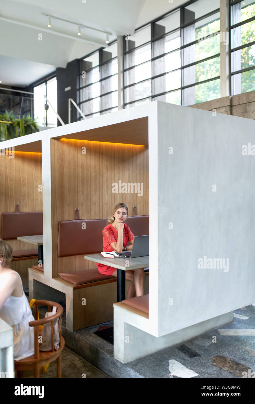 Lifestyle shot of trendy cafe with pretty blonde caucasian millennial ...