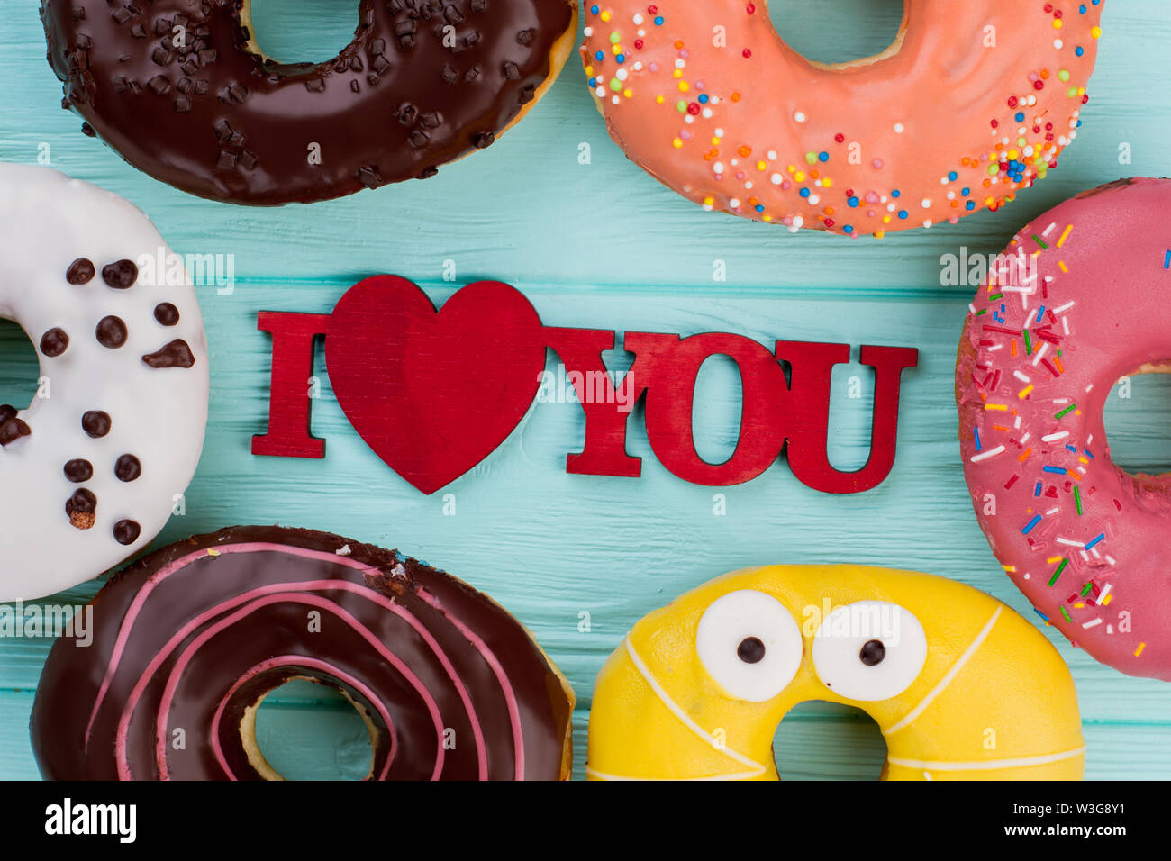 Romantic composition with assorted donuts Stock Photo - Alamy