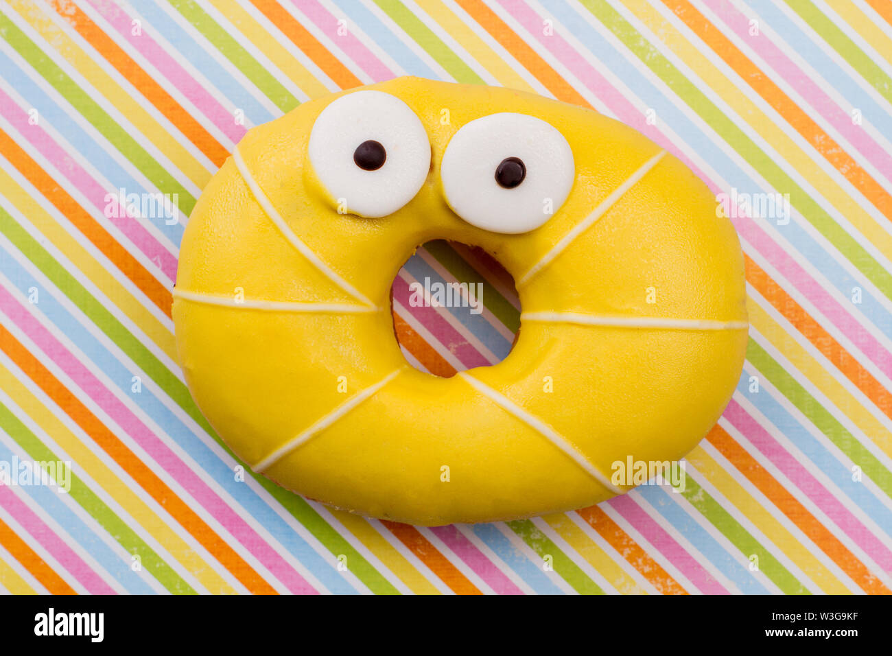 Funny yellow donut on colorful background Stock Photo - Alamy