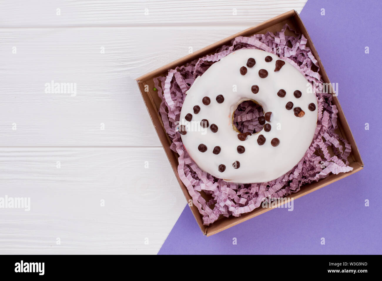 Box with decorated donut on color background Stock Photo - Alamy