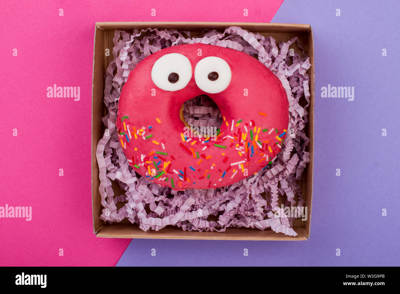 Funny donut in box, top view Stock Photo - Alamy
