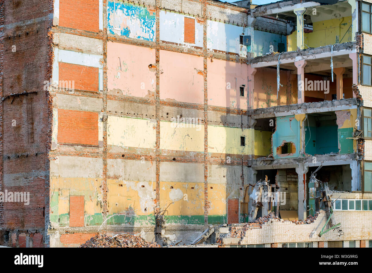 Partially destroyed industrial building with colored walls. Demolition ...
