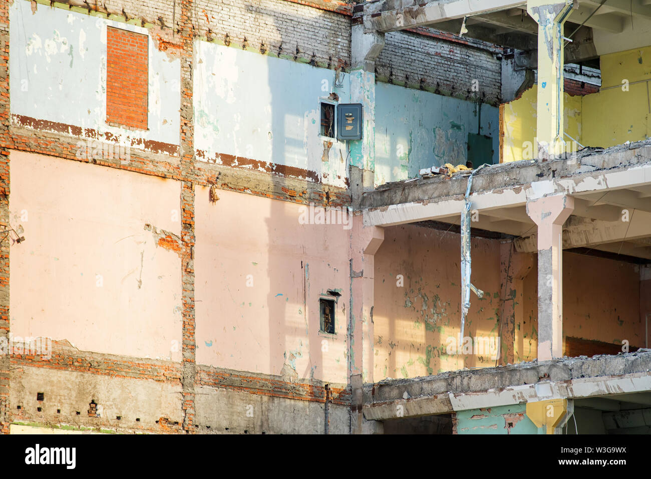 Modern partially destroyed industrial building with colored walls ...