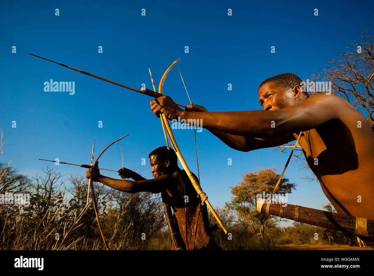 Bushman hunters with bow and arrow simulating a hunt at Grashoek ...