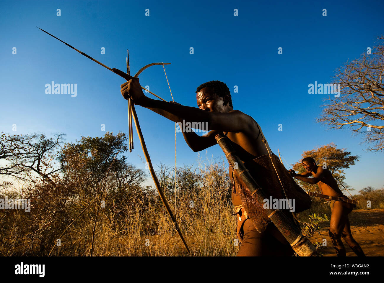 Bushman hunters with bow and arrow simulating a hunt at Grashoek ...