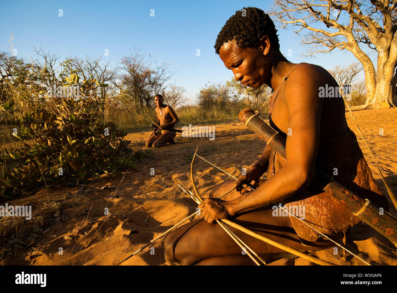 Bushman hunters with bow and arrow simulating a hunt at Grashoek ...