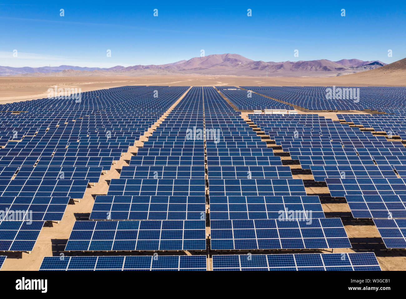 Aerial view of hundreds solar energy modules or panels rows along the ...