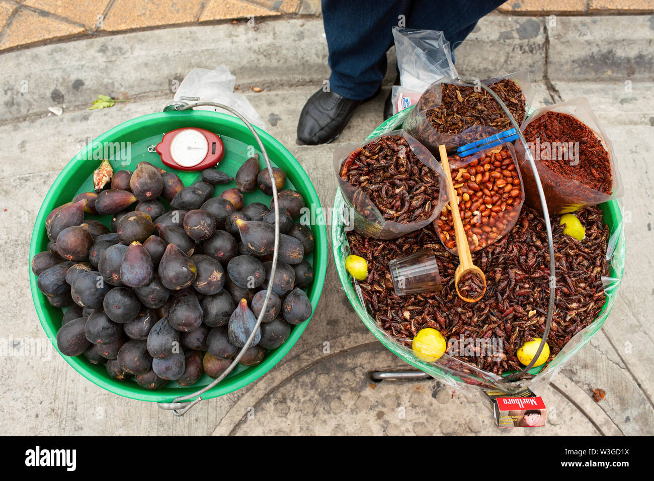 Local woman selling snacks: nuts, figs and edible grasshoppers ...