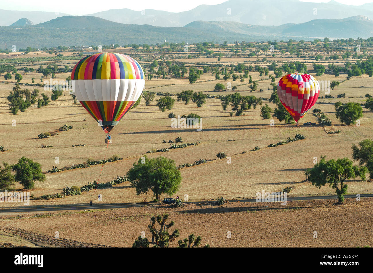 Colorful hot air balloons landing in rural farm fields Stock Photo - Alamy
