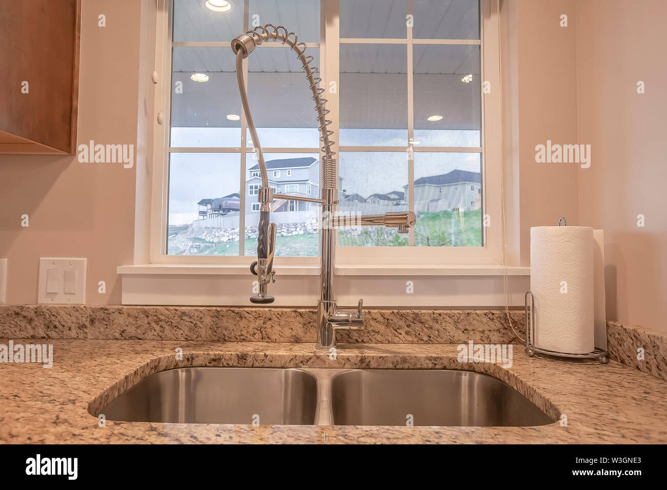 Stainless steel double basin sink and faucet inside the kitchen of a ...
