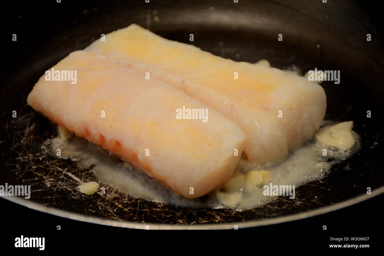 Cooking Cod Fillets on Butter and Garlic Stock Photo - Alamy