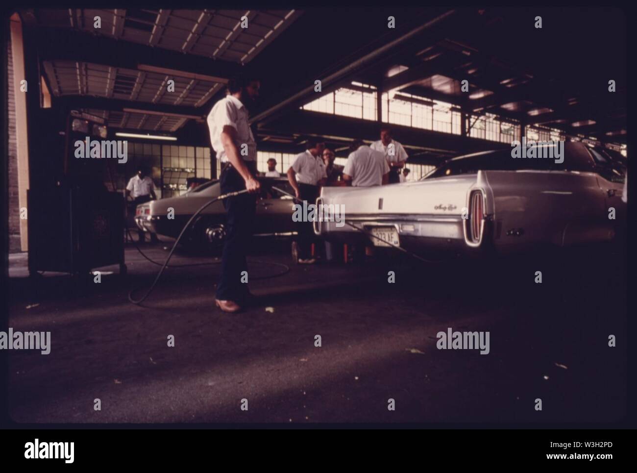 Employee at an auto emission inspection station in downtown cincinnati ...