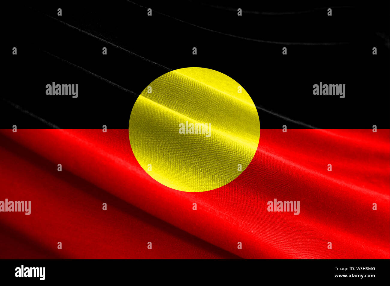 Realistic flag of Australian Aboriginal on the wavy surface of fabric ...