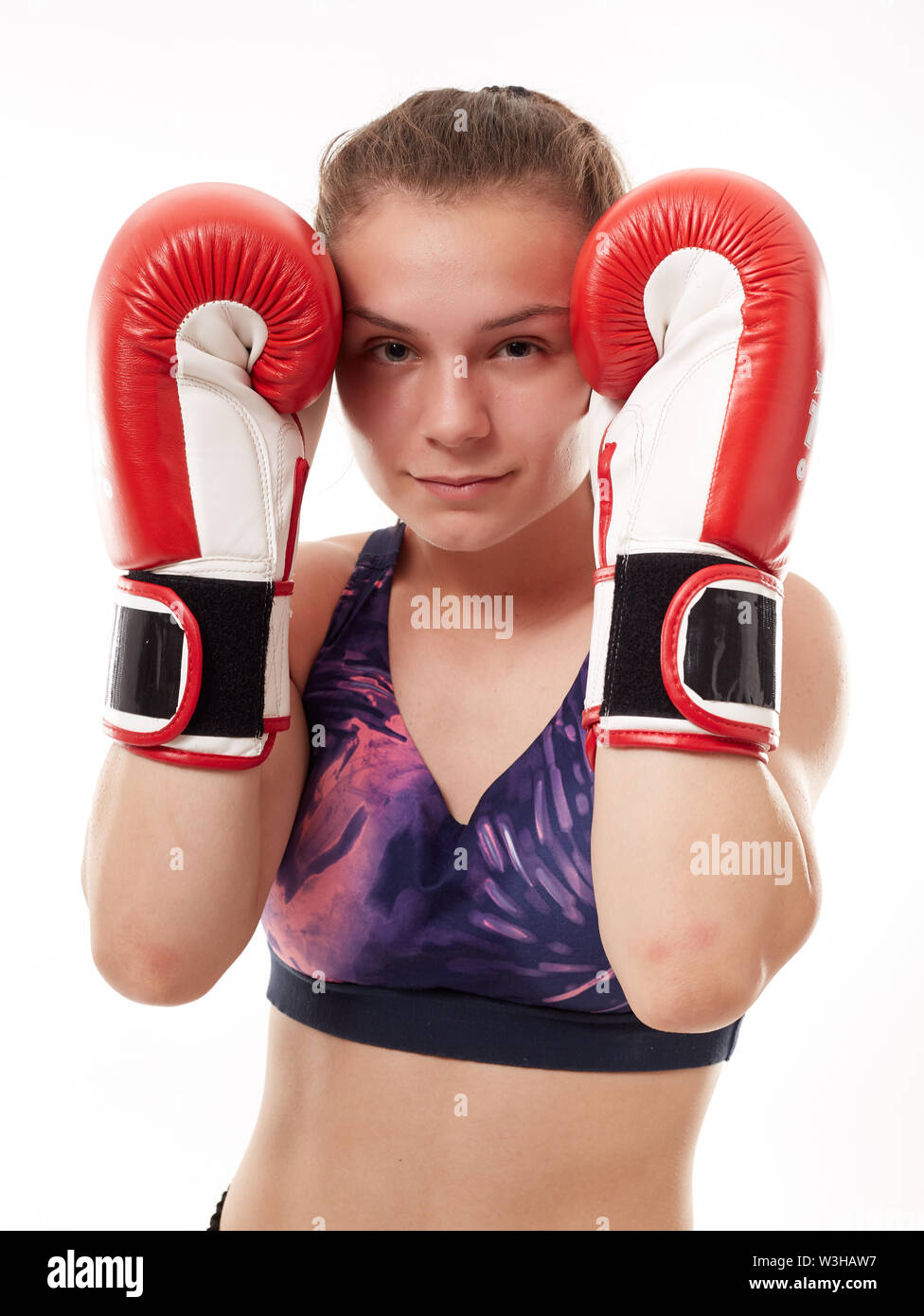 Young girl kickboxing fighter training, isolated on white background ...