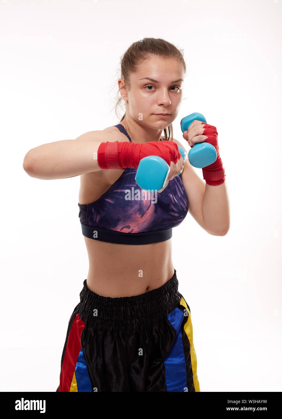 Young girl kickboxing fighter training, isolated on white background ...