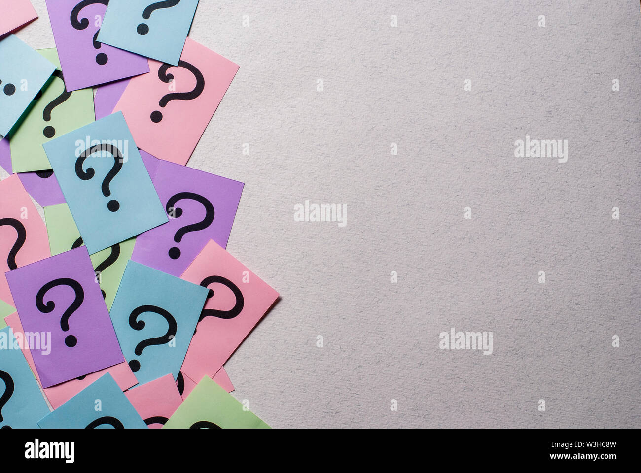 Side border of colorful question marks on multicolored paper in a ...
