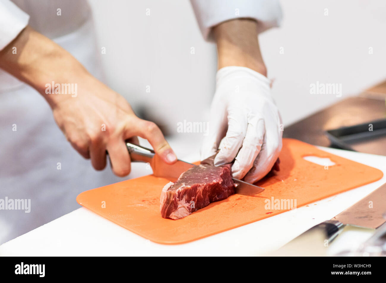 Professional chef cutting fresh meat hi-res stock photography and ...