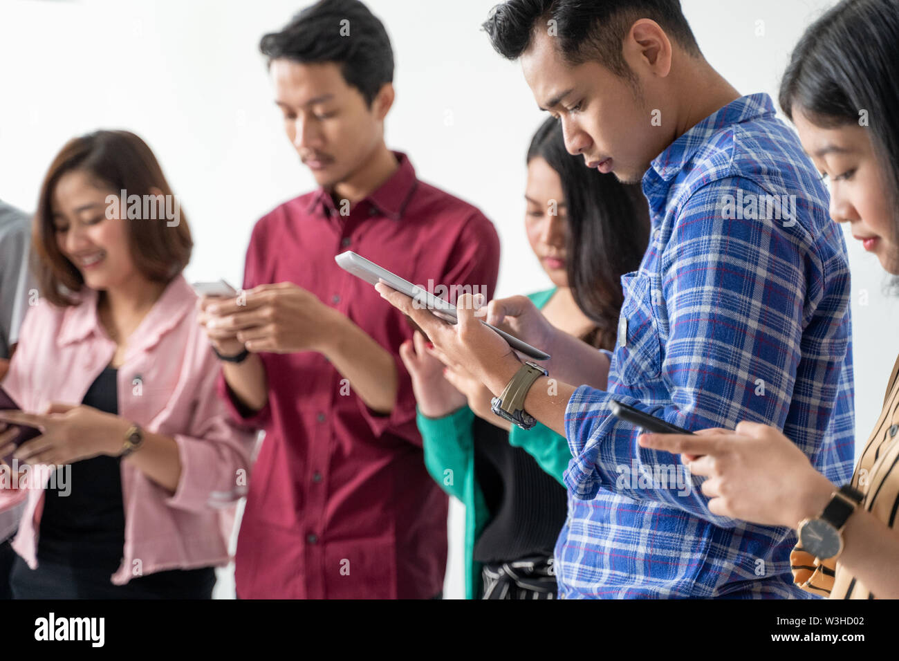 best friend holding handphone a cell phone individually Stock Photo - Alamy