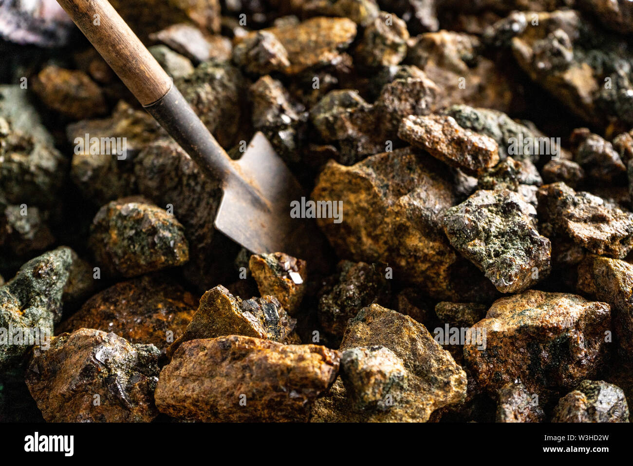 Mining. A miniature shovel and pieces of minerals with crystals Stock ...
