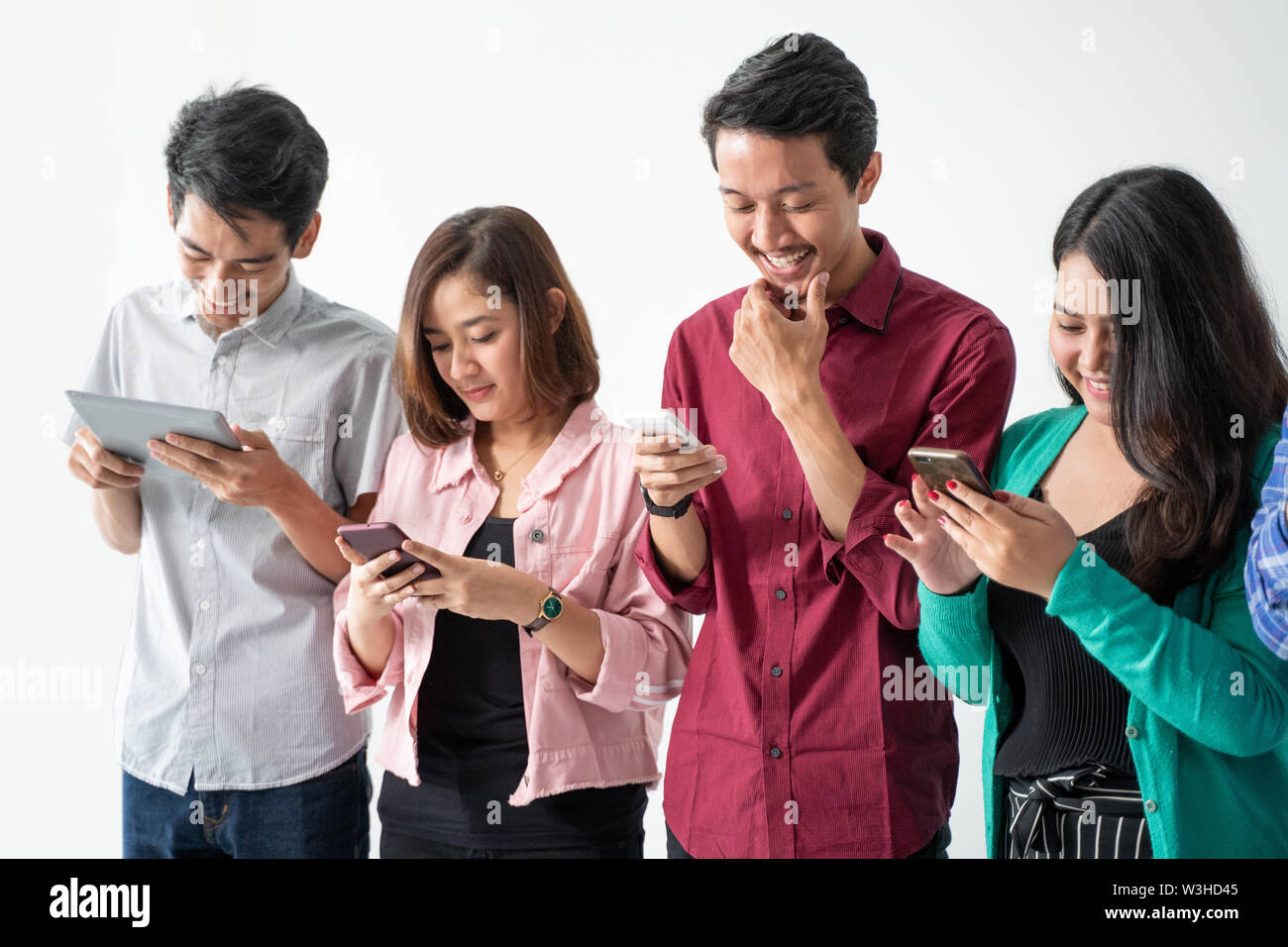 best friend holding handphone a cell phone individually Stock Photo - Alamy