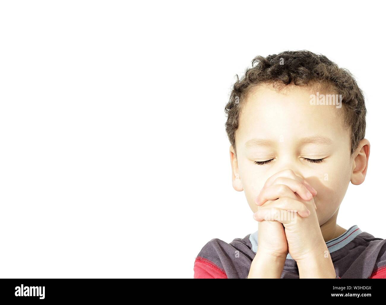 little boy praying to God and being religious stock image with hands ...