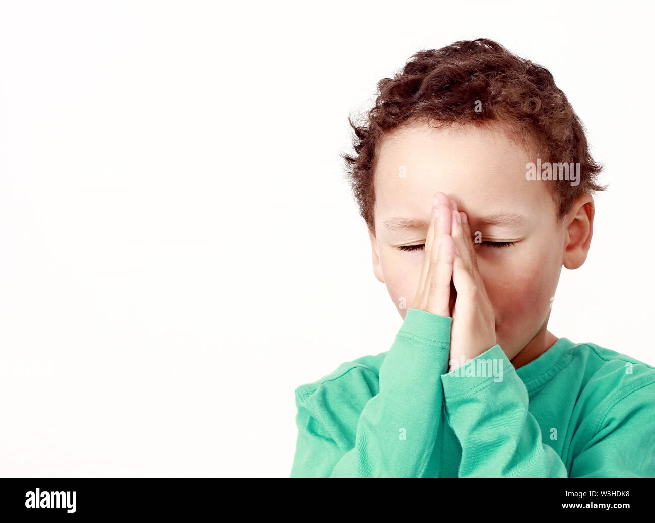 little boy praying to God and being religious stock image with hands ...