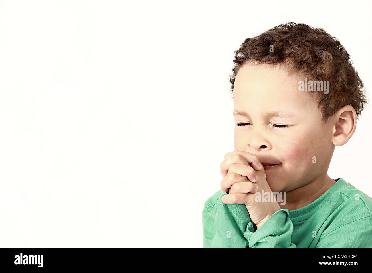 little boy praying to God and being religious stock image with hands ...