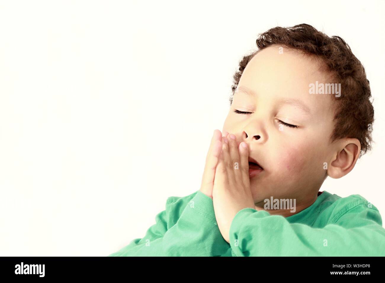 little boy praying to God and being religious stock image with hands ...