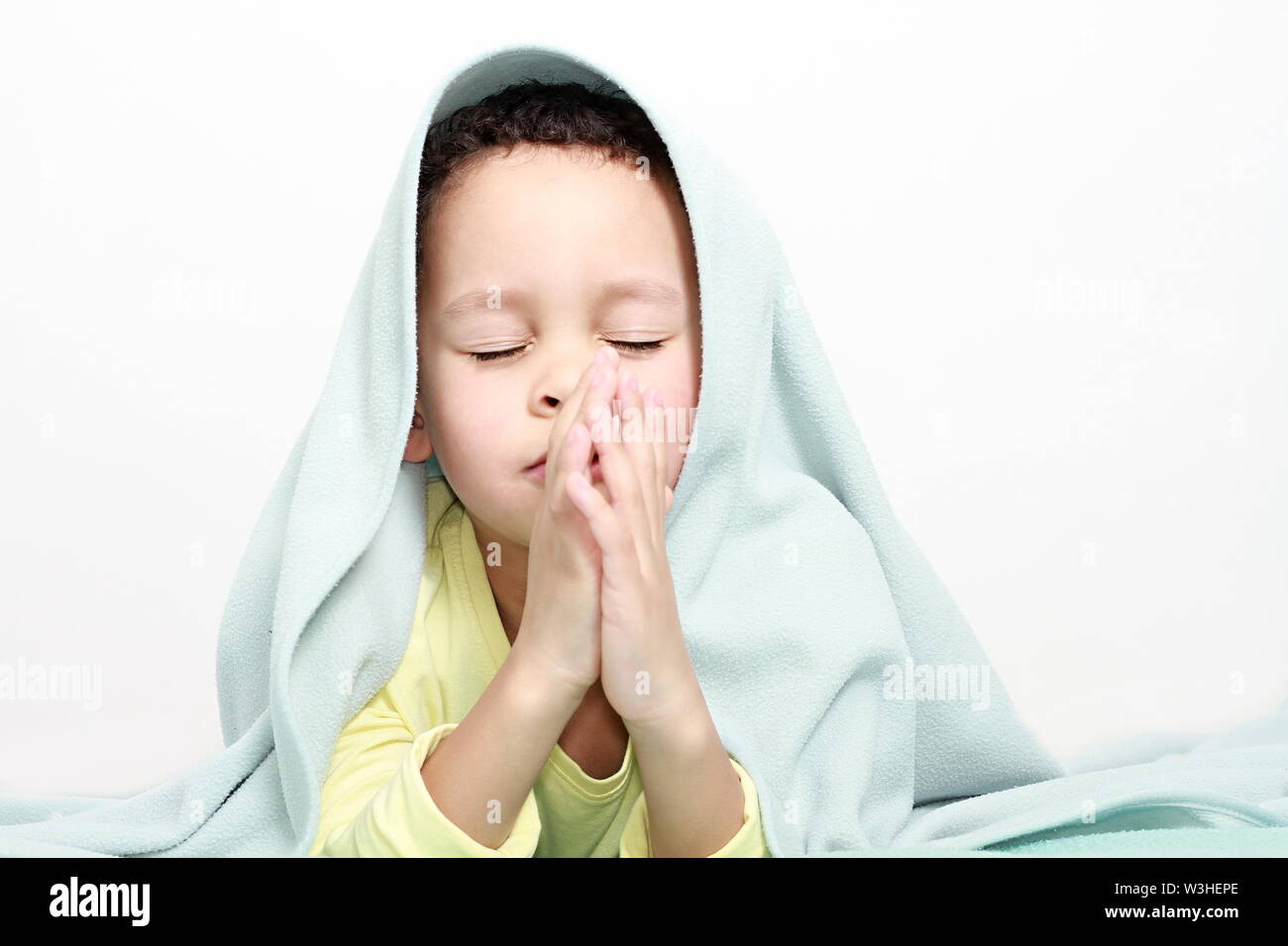 little boy praying to God and being religious stock image with hands ...