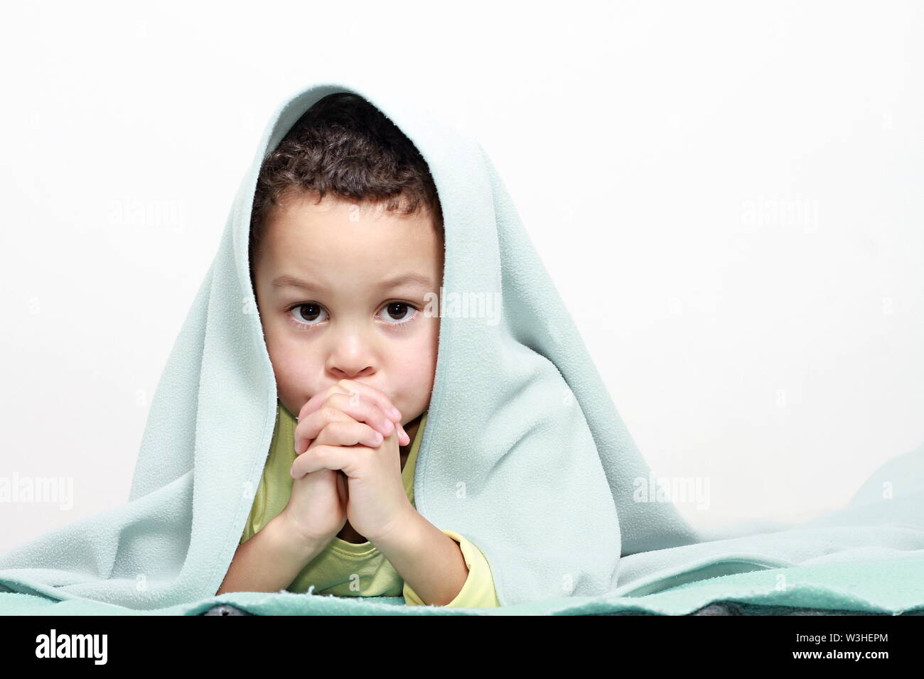 little boy praying to God and being religious stock image with hands ...