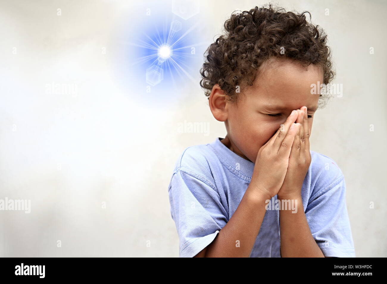 little boy praying to God and being religious stock image with hands ...