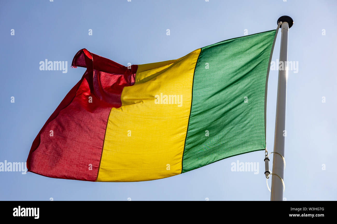 Mali flag, Mali national symbol waving against clear blue sky, sunny ...