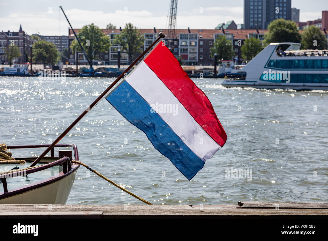 Netherlands flag. Dutch national symbol on a boat anchored in the river ...