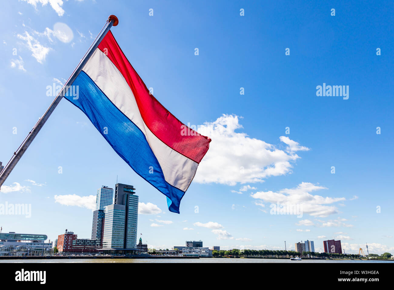 Netherlands flag waving, Highrise buildings background, sunny day in ...