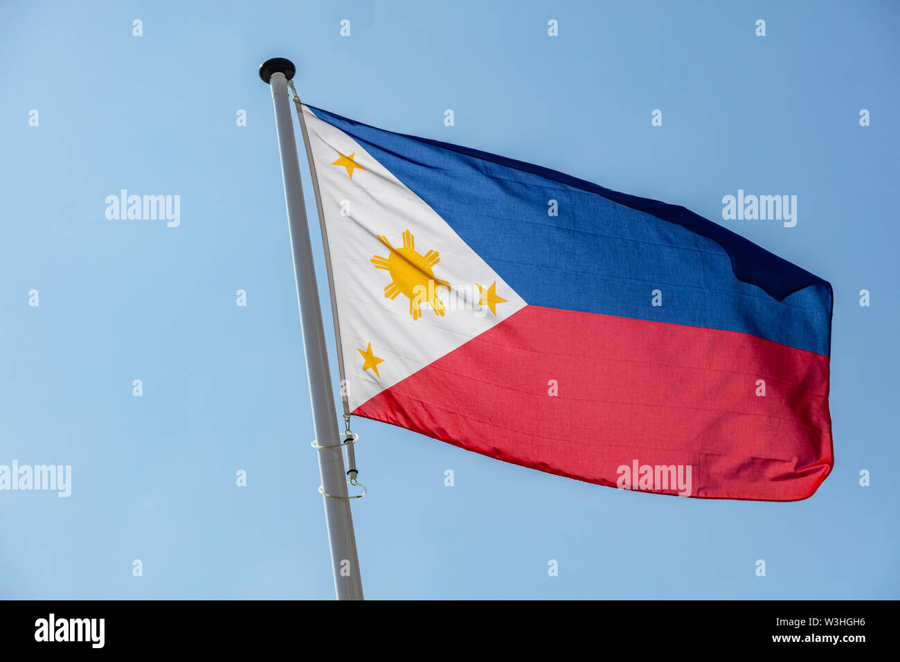 Philippines flag, Philippines national symbol waving against clear blue ...