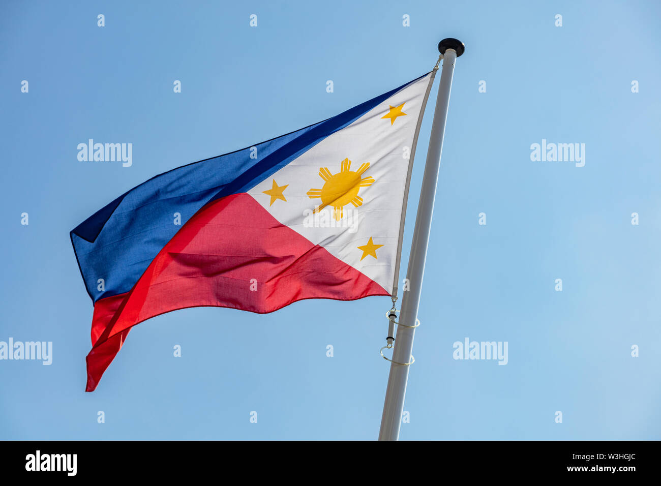 Philippines flag, Philippines national symbol waving against clear blue ...